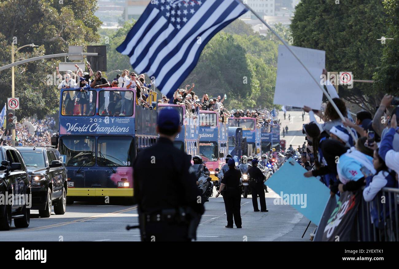 Los Angeles Dodgers players and coaches are paraded on buses during ...