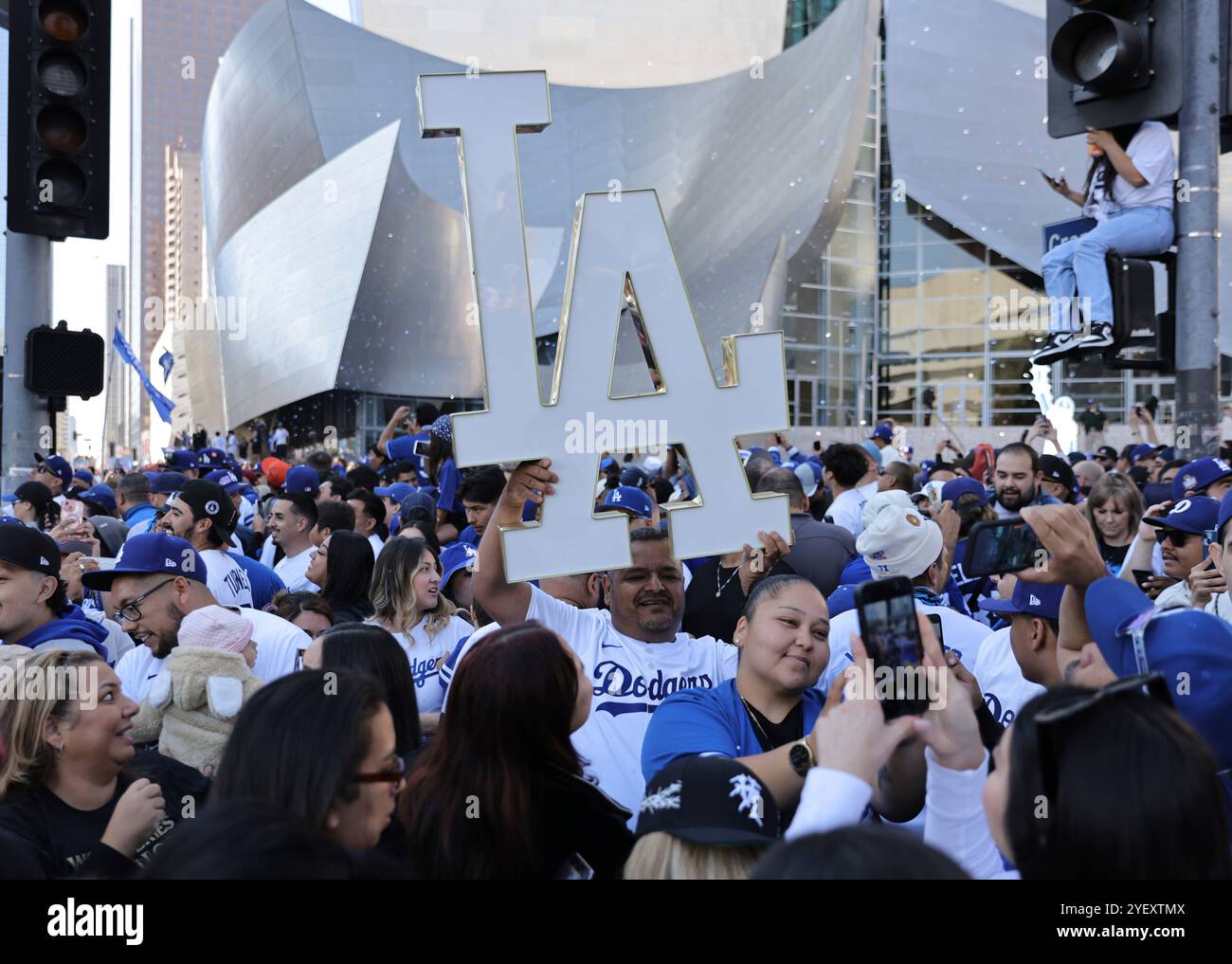 Fans cheer as buses carrying players are driven past during the Los ...