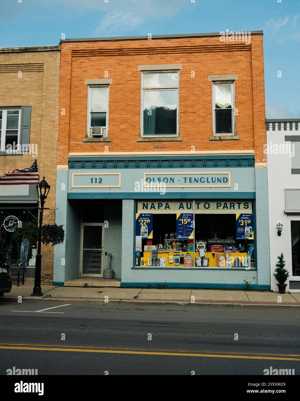 A view of a historic brick building with Olson-Tenglund Napa Auto Parts store in Coudersport ...