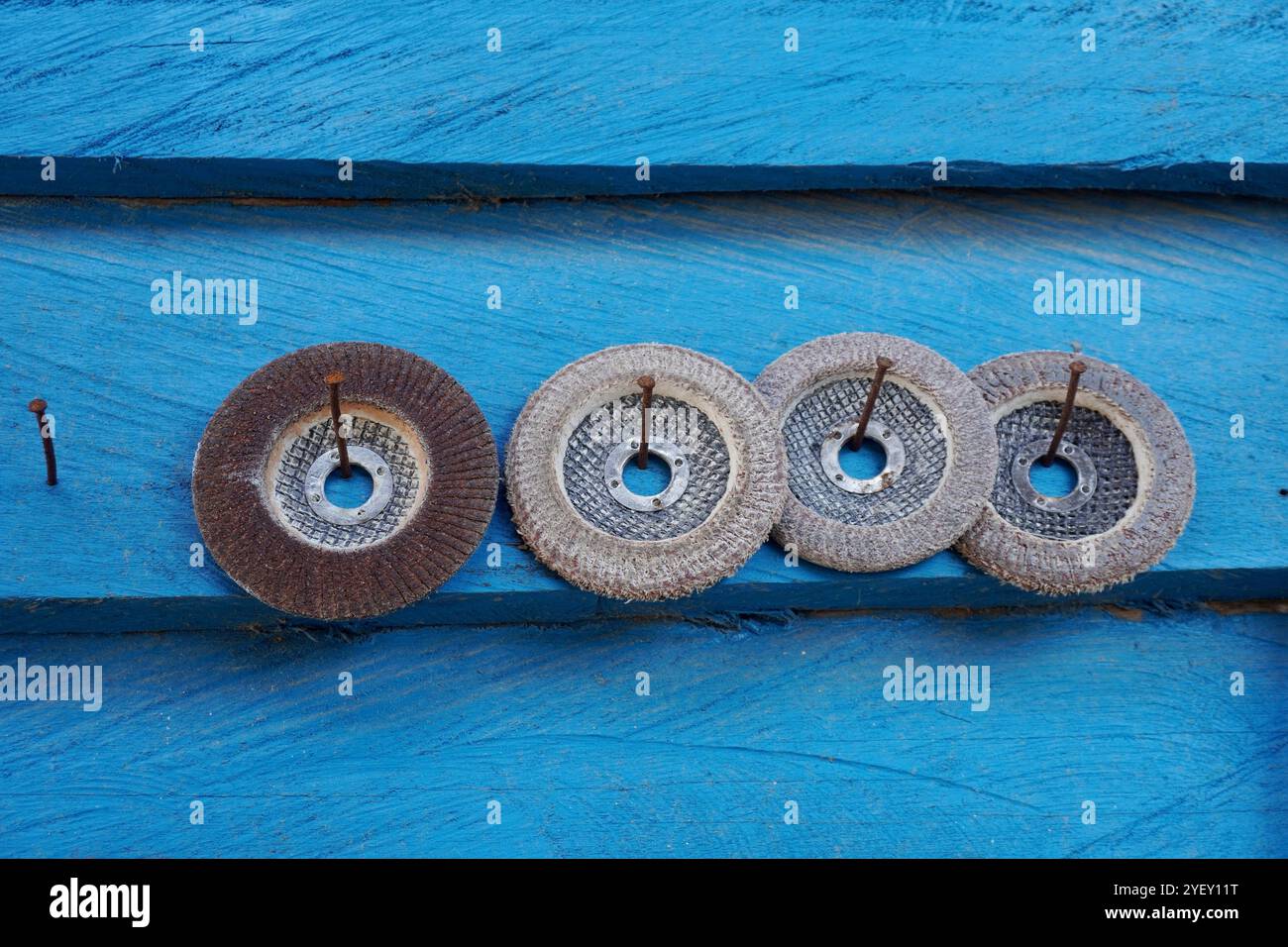 four old used round sandpaper bits stuck to the wall Stock Photo - Alamy