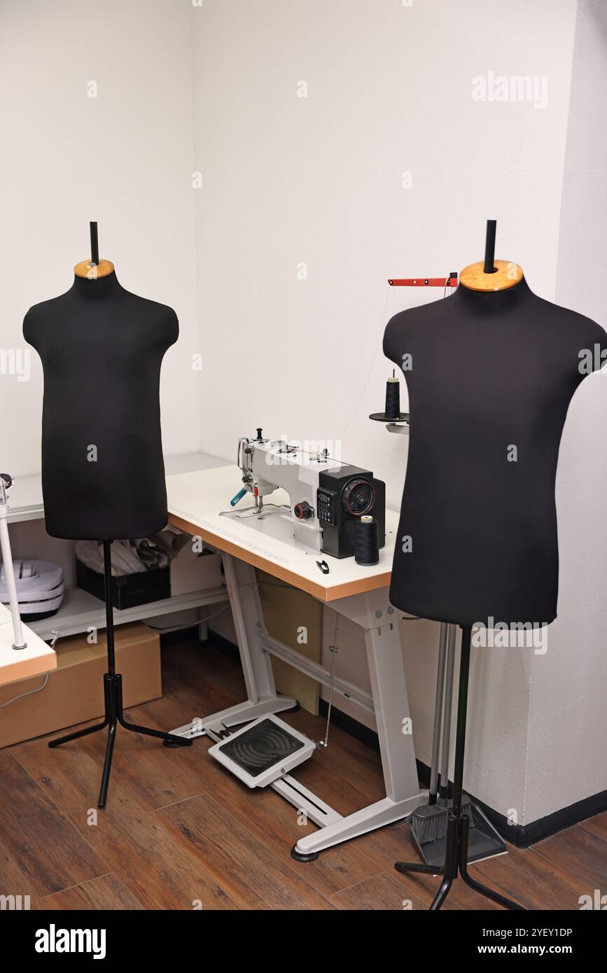 Professional workshop with sewing machine, table and mannequins Stock ...