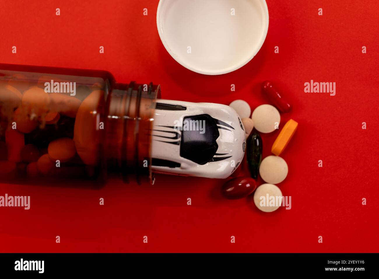 White toy car speeds out of a pill bottle, leaving a trail of colorful ...