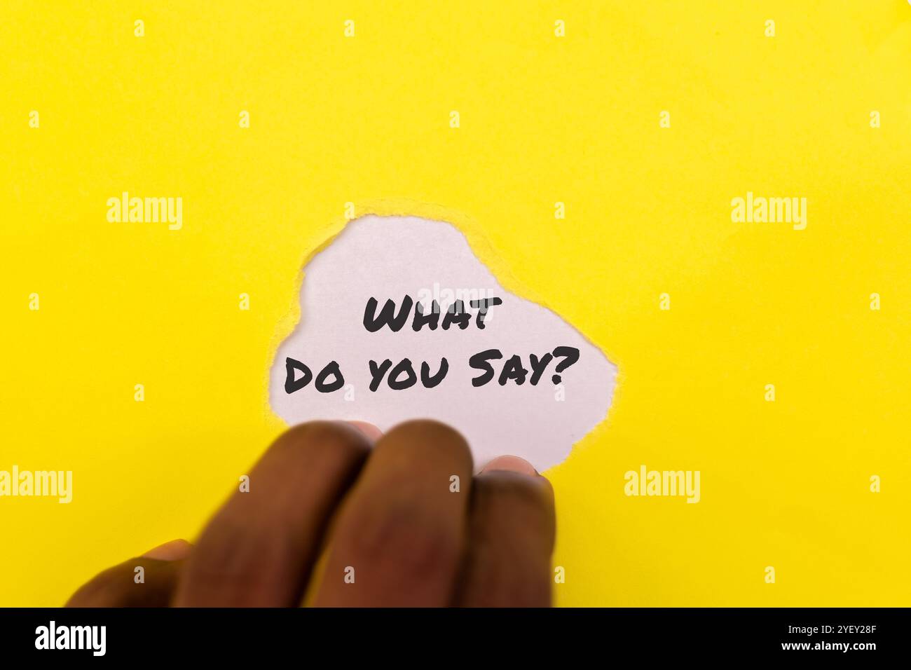 Hand reveals hidden message on bright yellow background. Intrigue ...