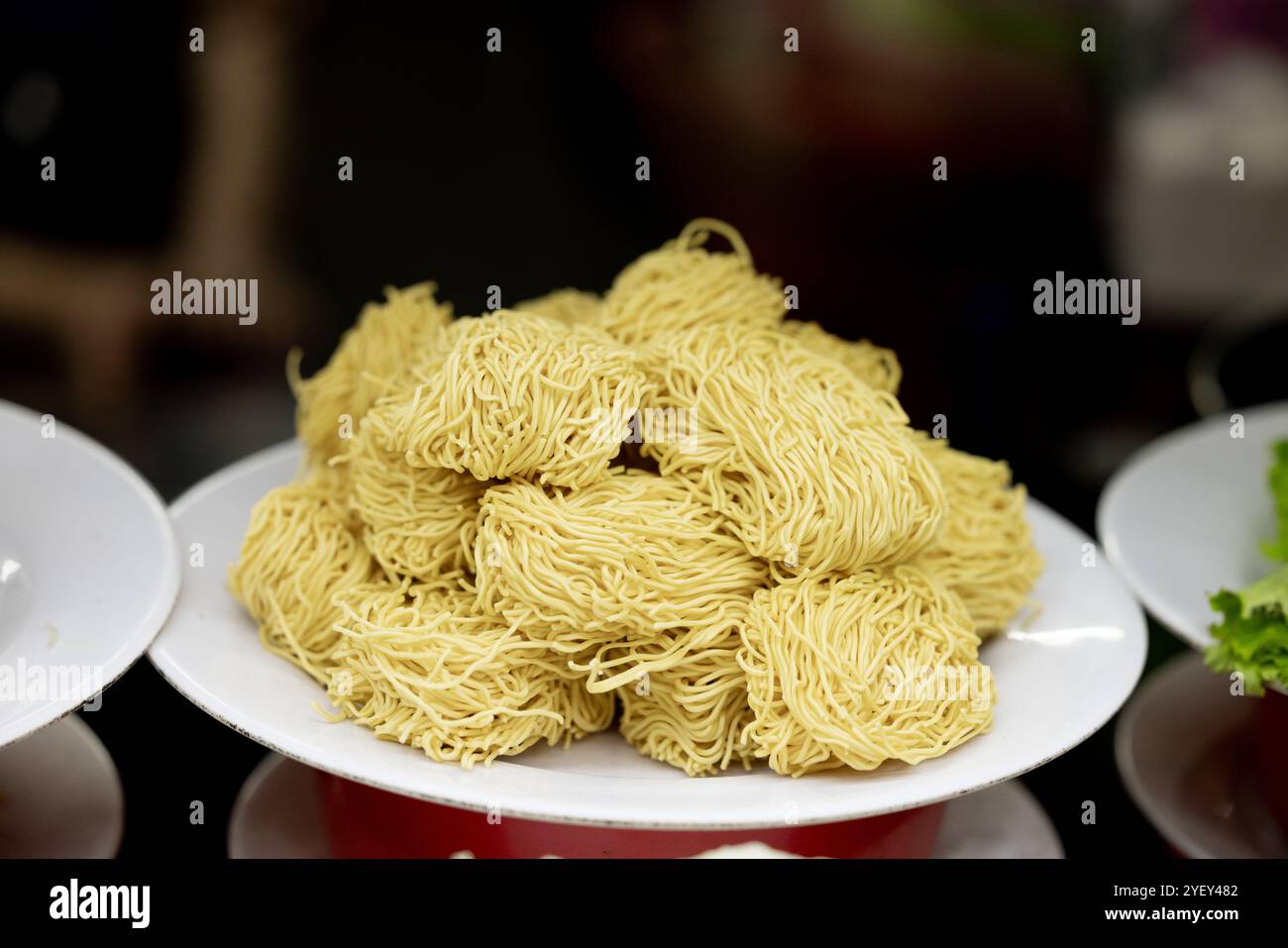 dry noodles for cooking in hot water on a black background. Asian ...