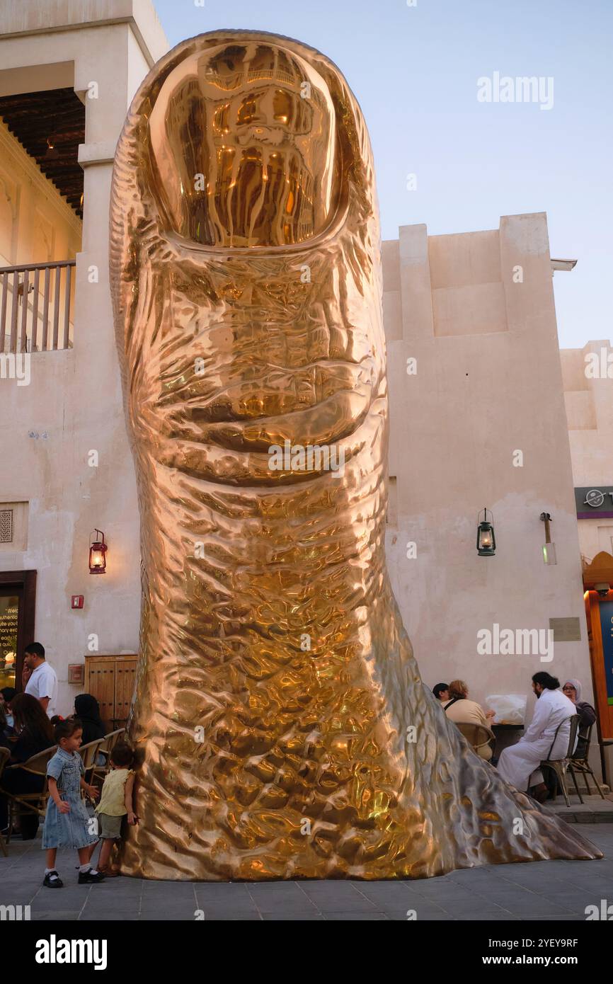 Le Pouce giant golden thumb statue in Qatar, Souq Waqif Stock Photo - Alamy