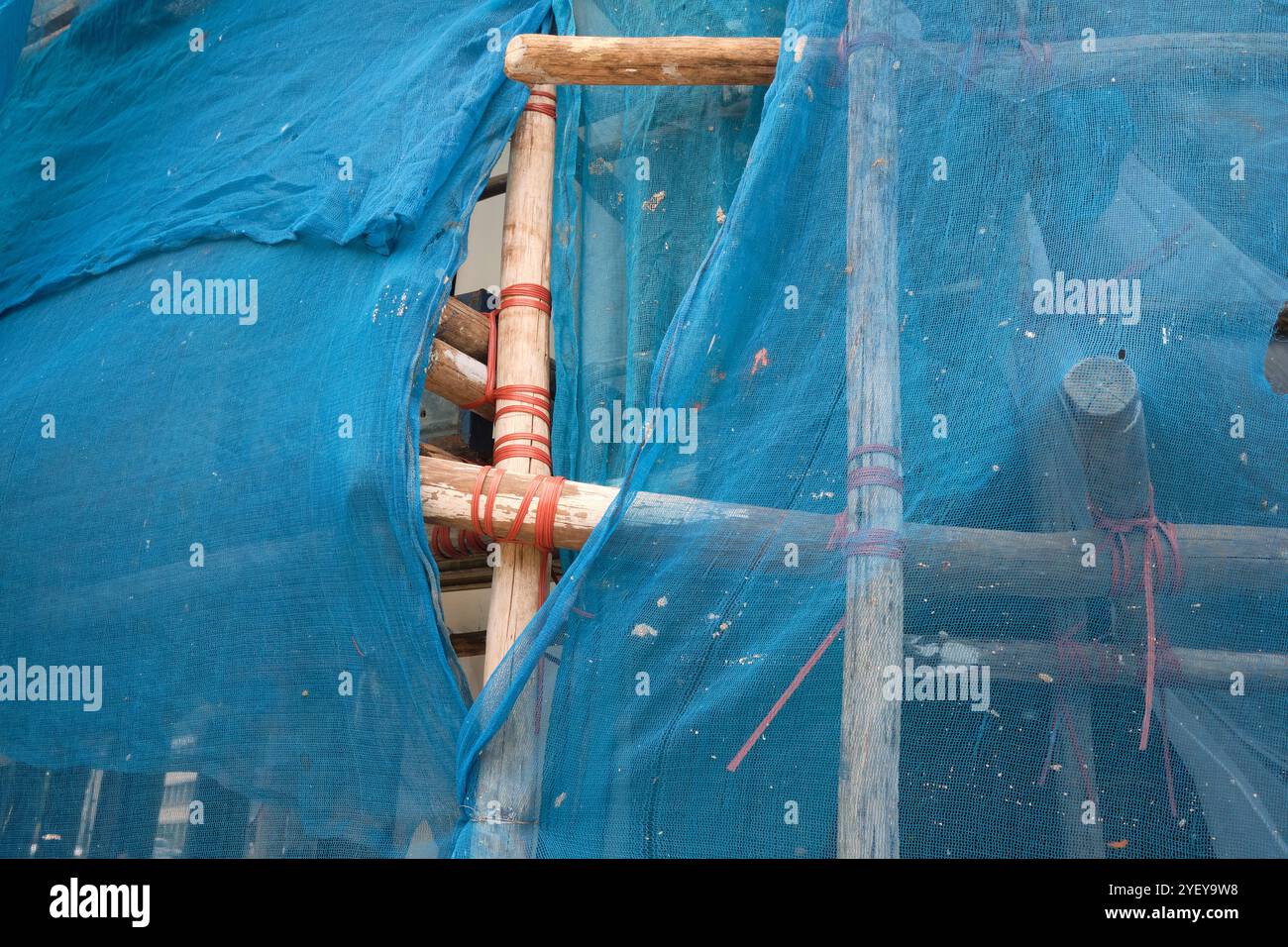Wooden scaffolding junction held together by plastic wire and covered ...