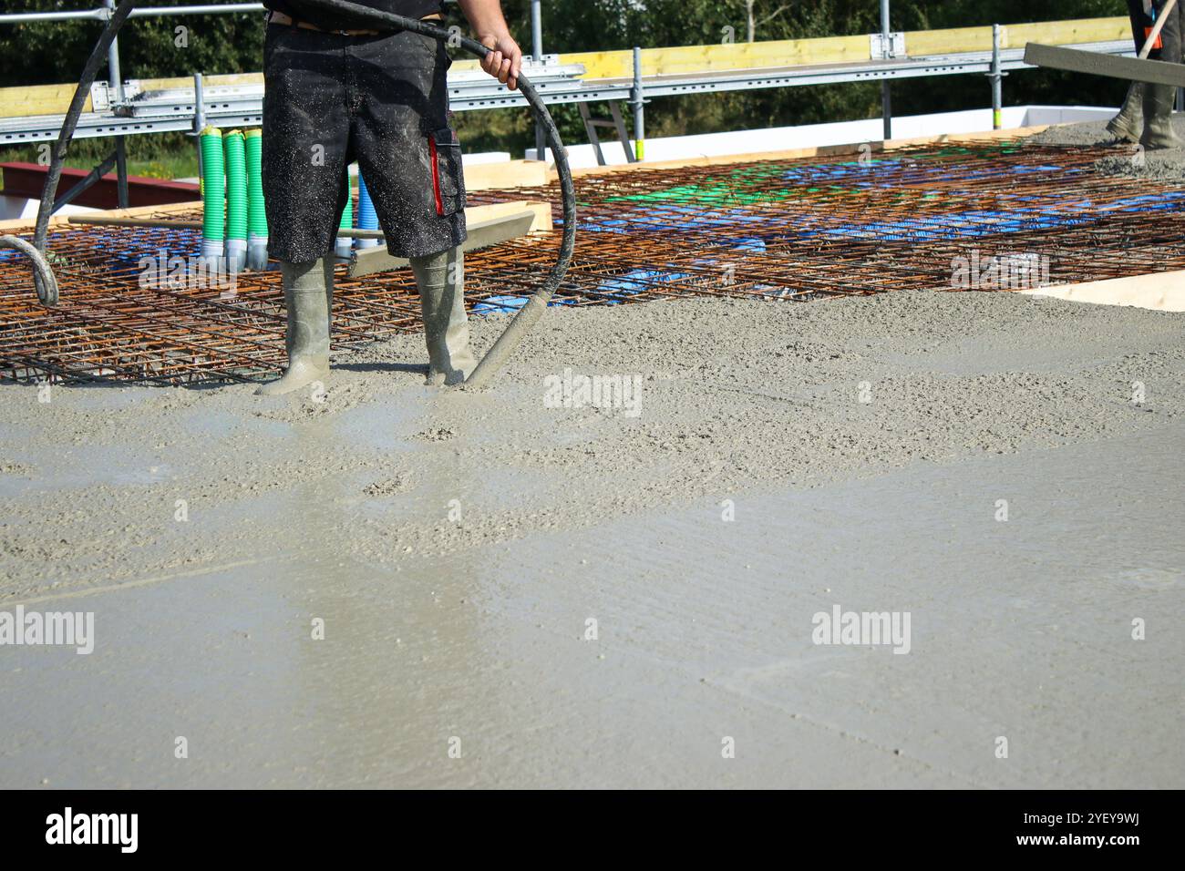 Workers filling the second floor ground with concrete, core and shell ...