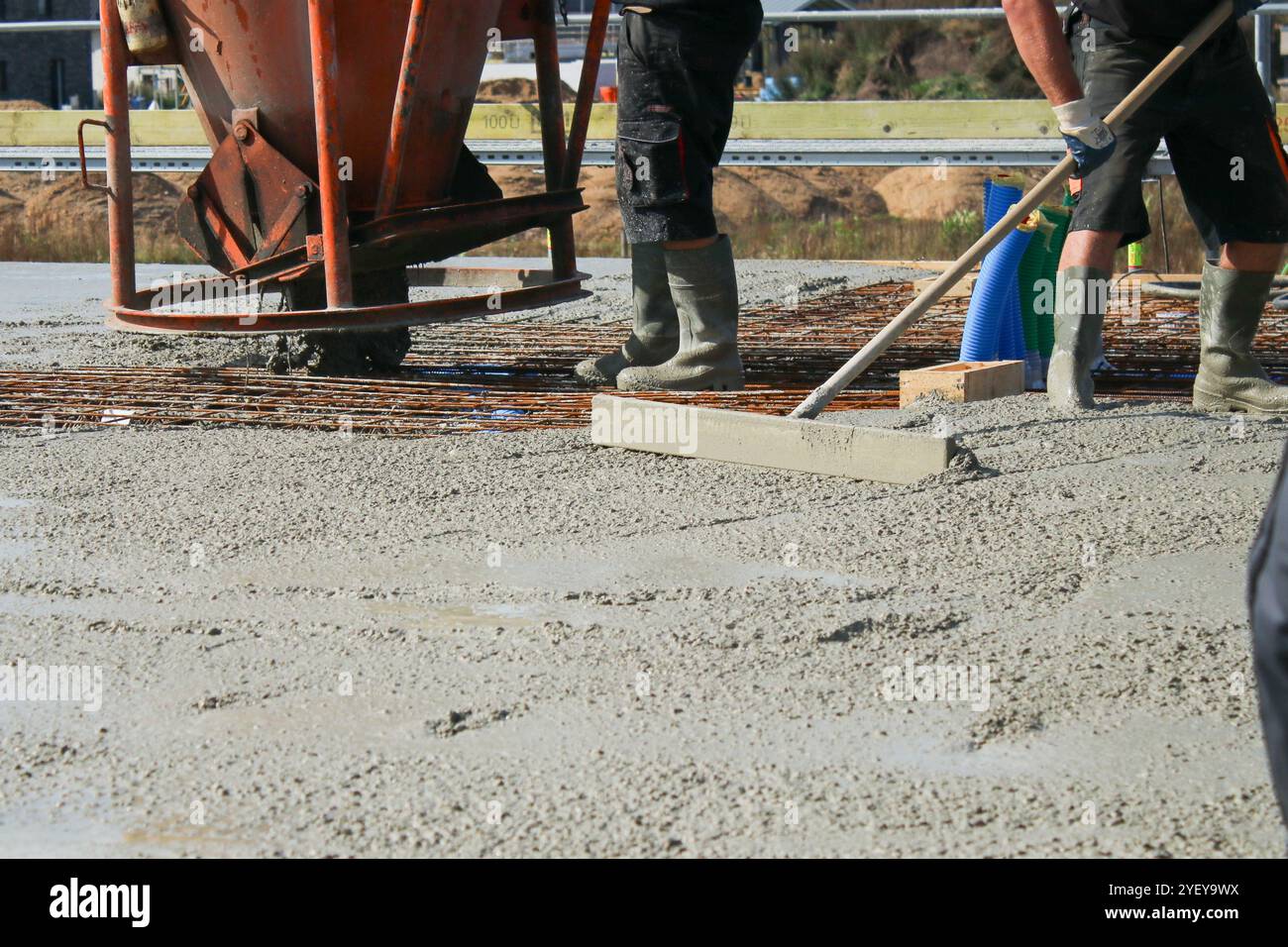 Workers filling the second floor ground with concrete, core and shell ...