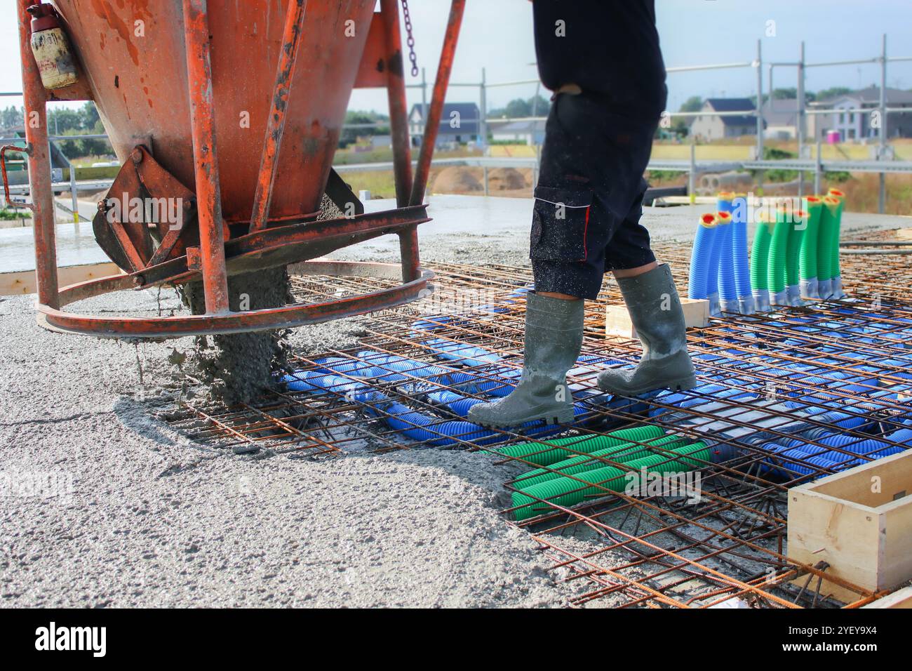 Workers filling the second floor ground with concrete, core and shell ...