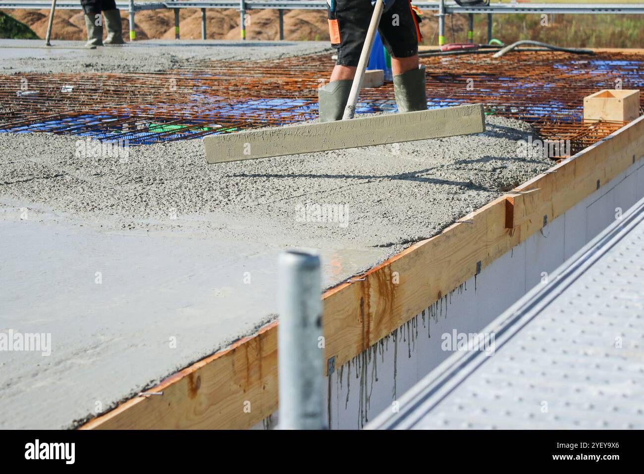 Workers filling the second floor ground with concrete, core and shell ...