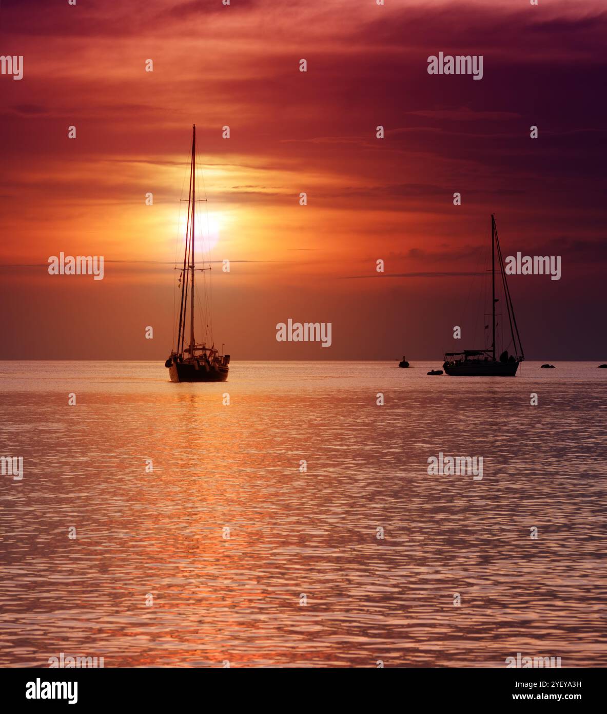 Sailboats at dusk. Tropical landscape Stock Photo - Alamy