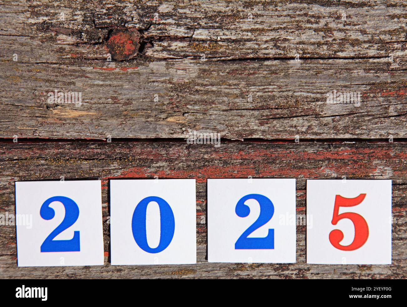 Numbers of 2025 year. Paper square numbers on the wooden background ...