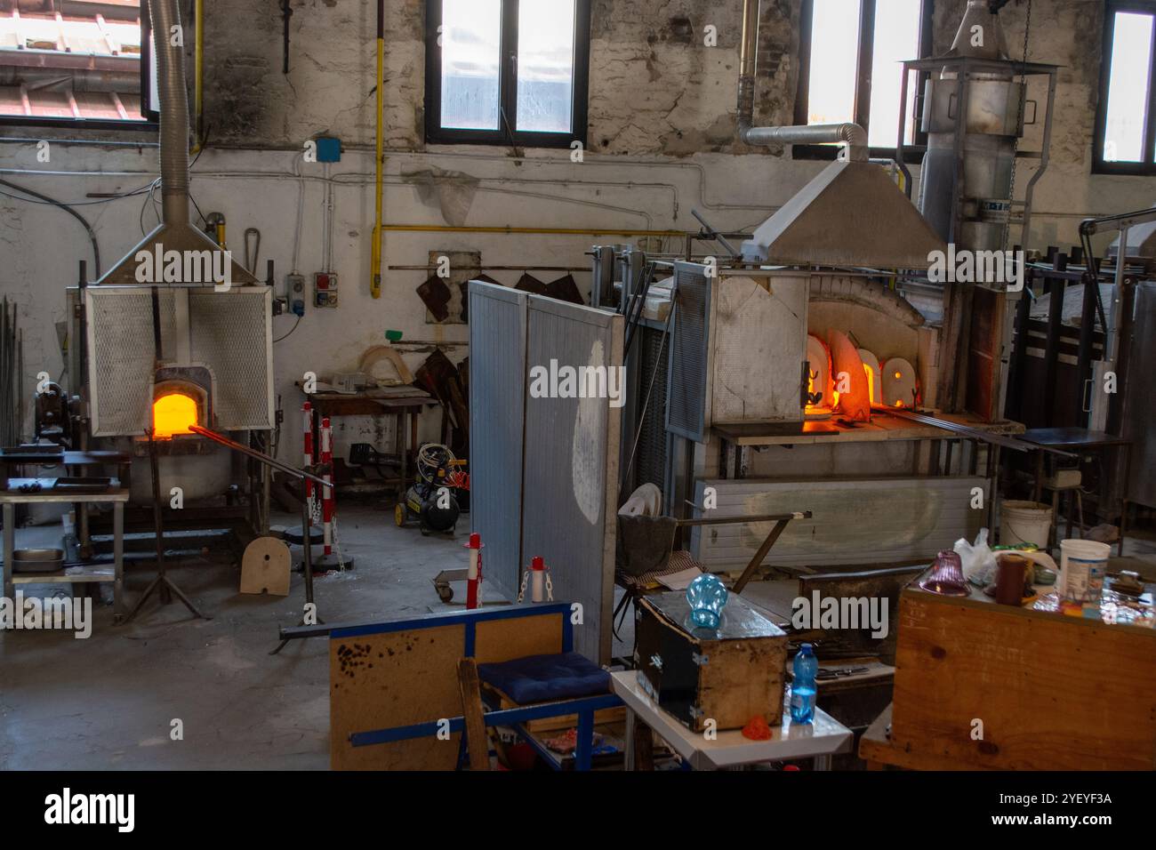 Murano glass-blowing factory. blower forming beautiful piece of glass ...
