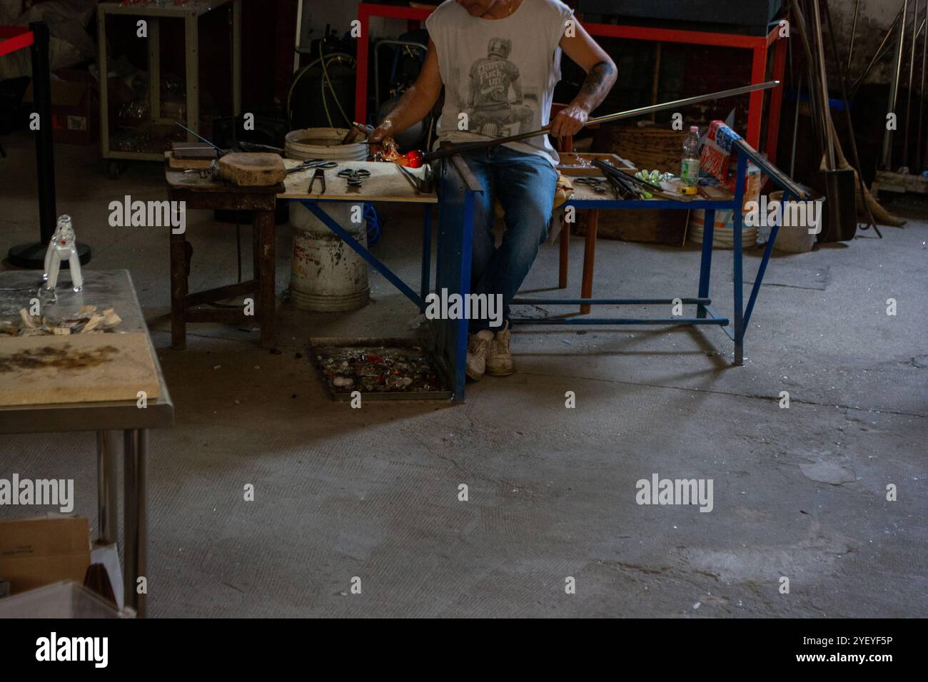 Murano glass-blowing factory. blower forming beautiful piece of glass ...