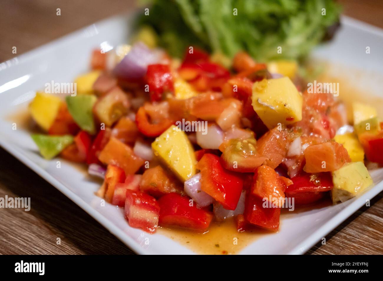 Spicy Salmon sashimi with mango salad served on plate Stock Photo - Alamy