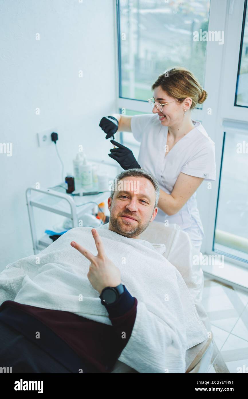 Male cosmetology in a beauty salon. A man takes care of his facial skin ...