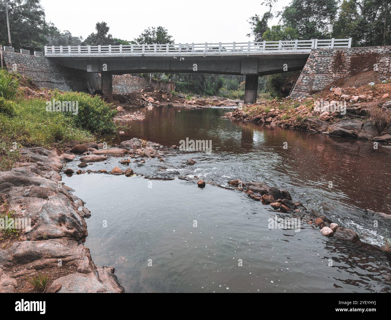 A highway bridge across the scenic Muthirapuzha River near Munnar ...