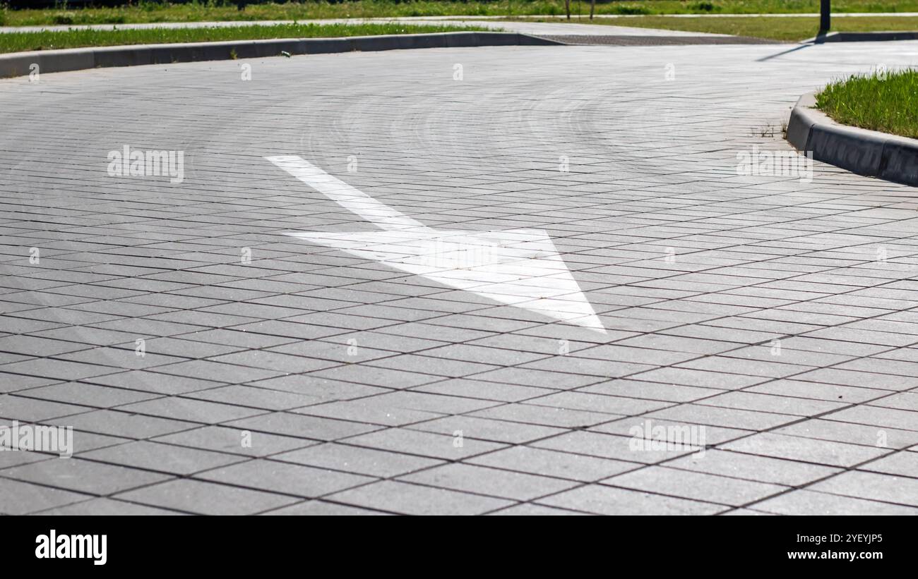 A large white arrow, designed to point towards the right direction, is ...