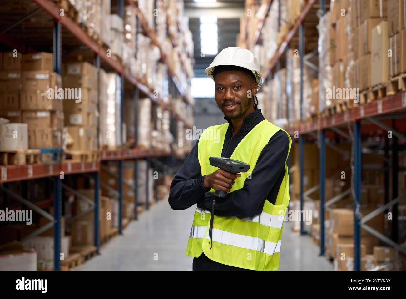 Warehouse worker holding barcode scanner managing inventory logistics ...