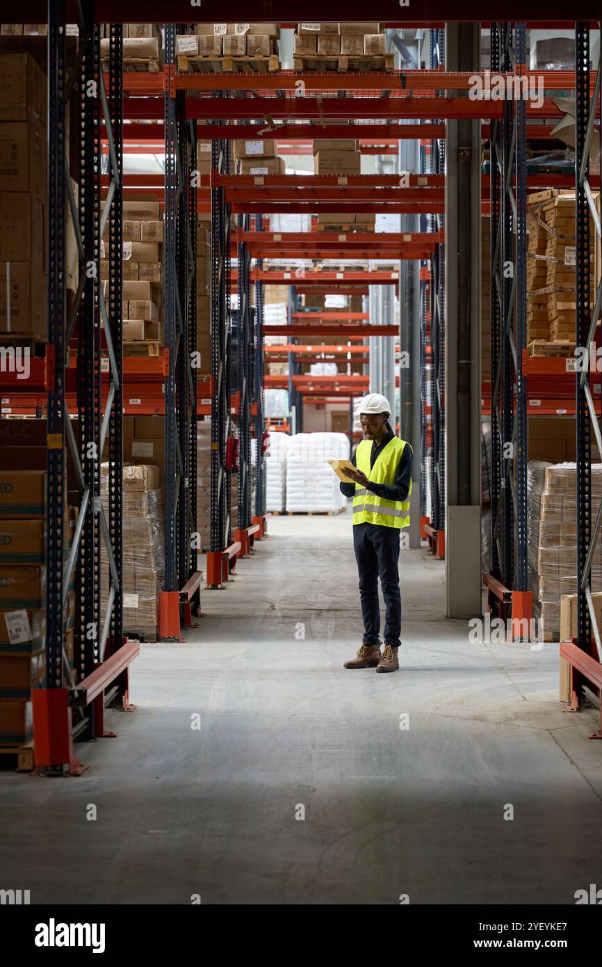 Warehouse worker using digital tablet checking inventory in logistics ...