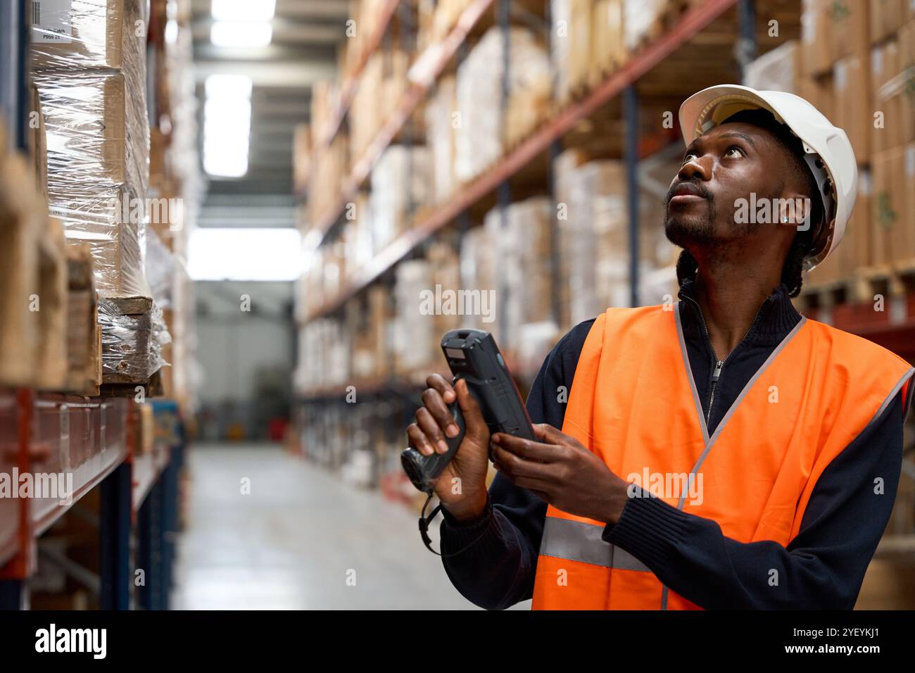 Warehouse worker scanning packages with barcode scanner in logistics ...