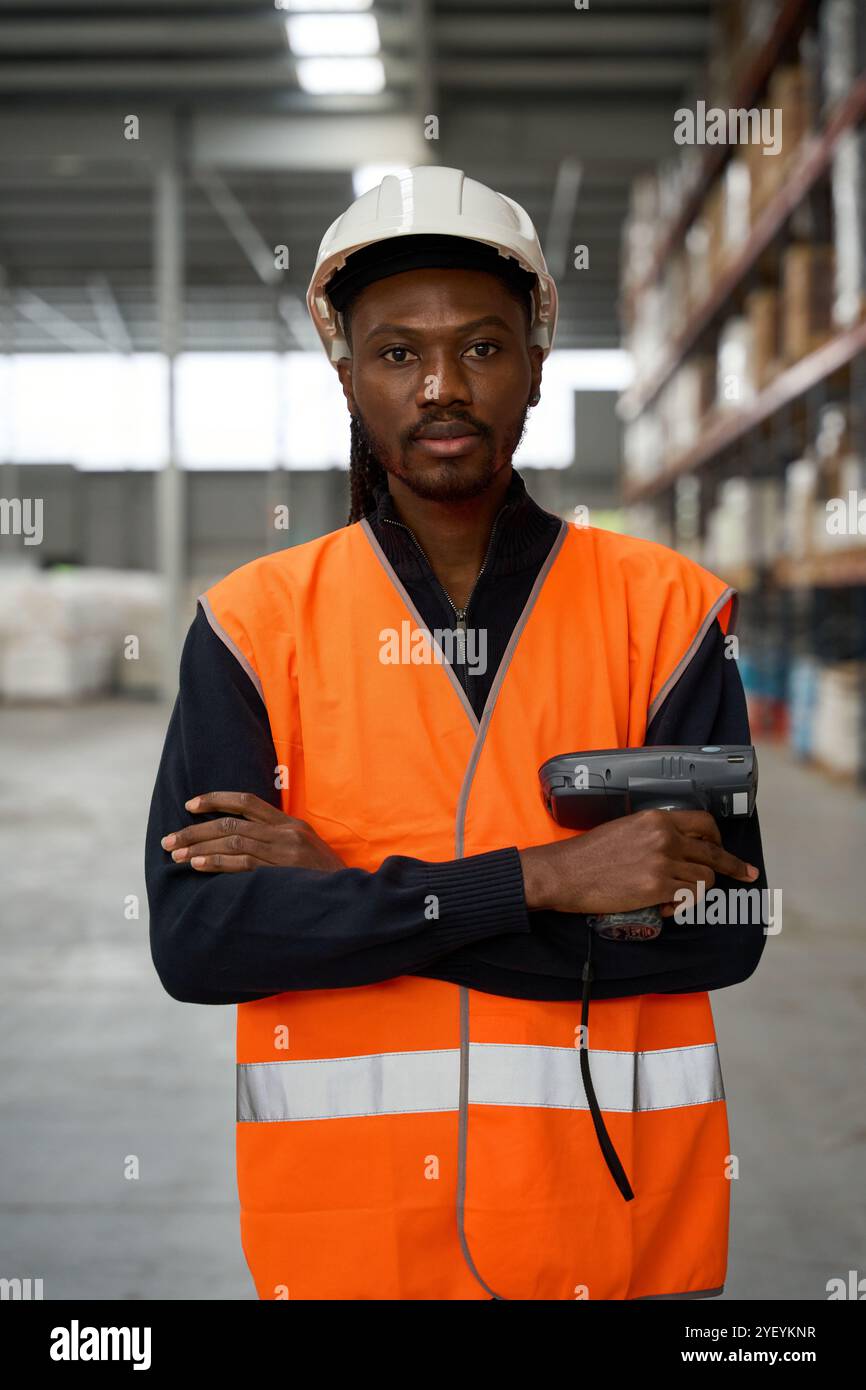 Warehouse worker holding scanner managing inventory and logistics Stock ...