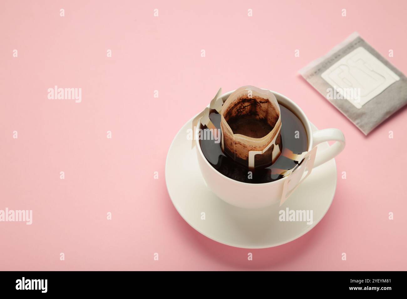 Drip coffee bag with ground coffee in cup. Making freshly brewed coffee ...