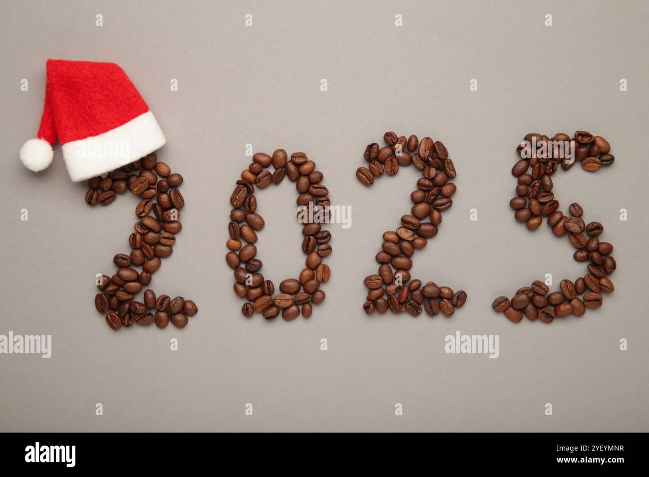 The inscription number 2025 laid out from coffee beans with Santa Claus ...