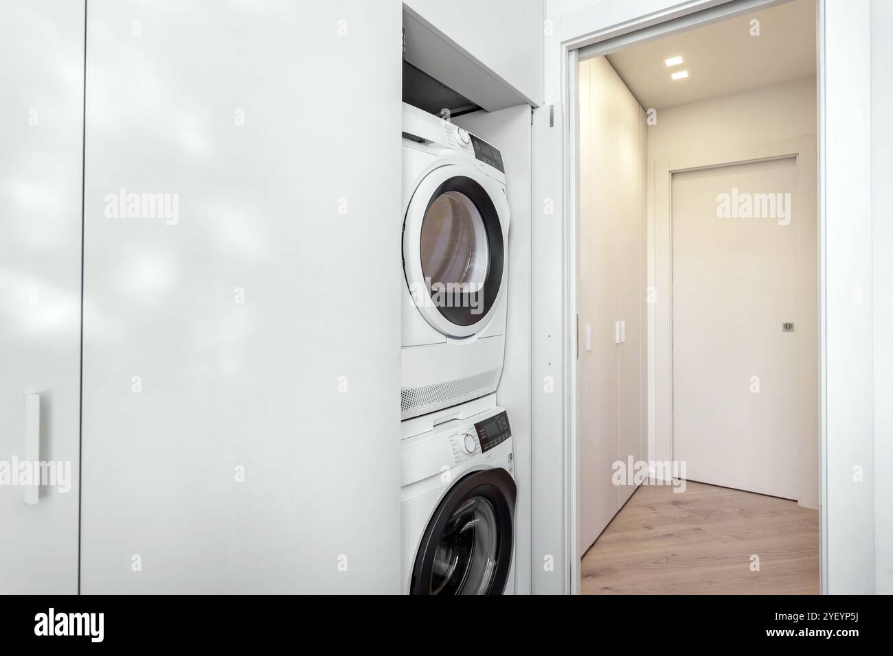 Interior of modern laundry room with washing machines and clothes dryer ...