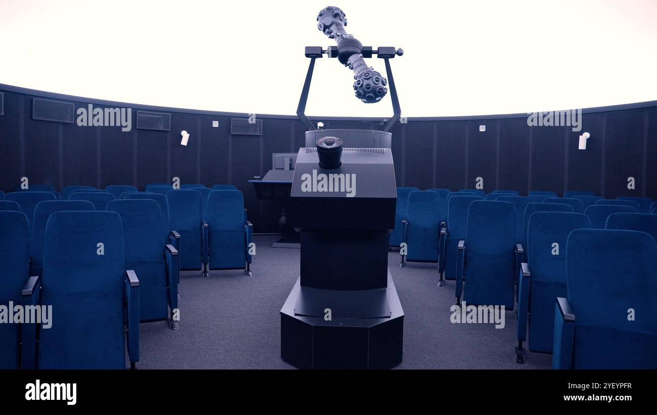 Modern planetarium projector standing in the middle of a circular ...