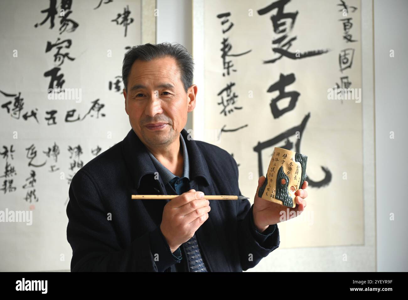 (241102) -- LONGDE, Nov. 2, 2024 (Xinhua) -- Yang Jianian shows a pen ...