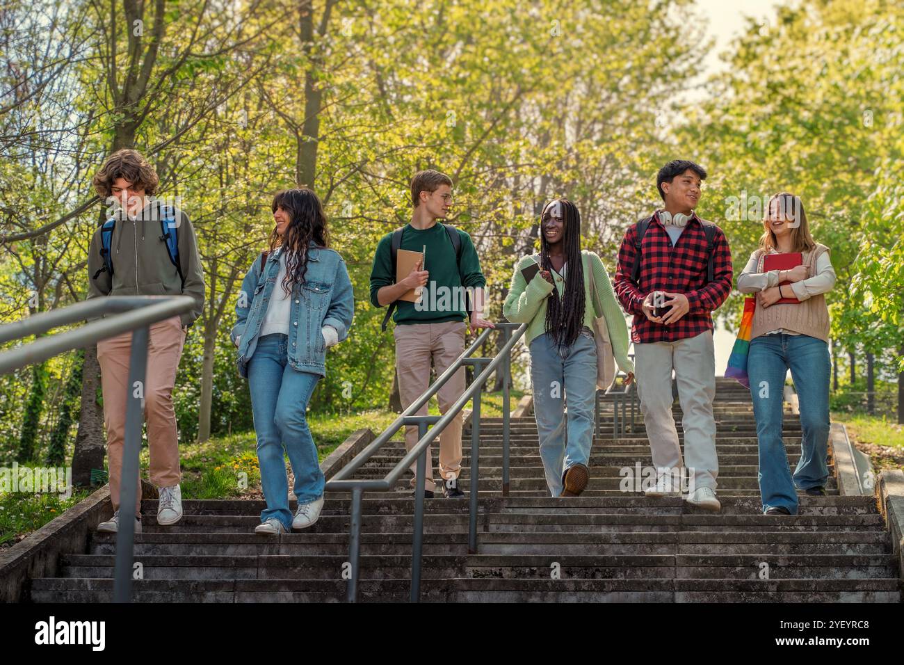 Modern university students descending concrete stairs on campus during ...
