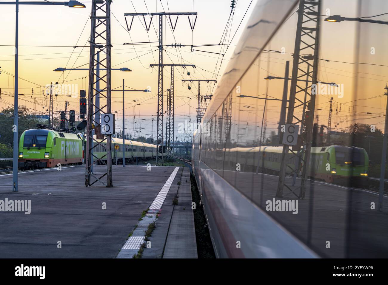 Flixtrain train arriving at Essen central station, reflected in an ICE ...