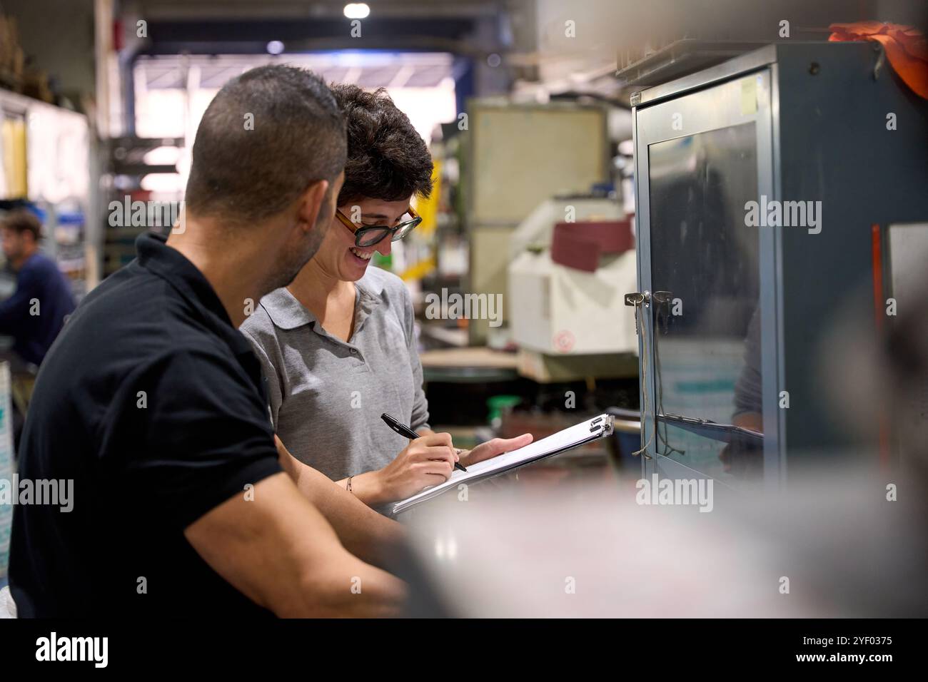Workers discussing production process hi-res stock photography and ...