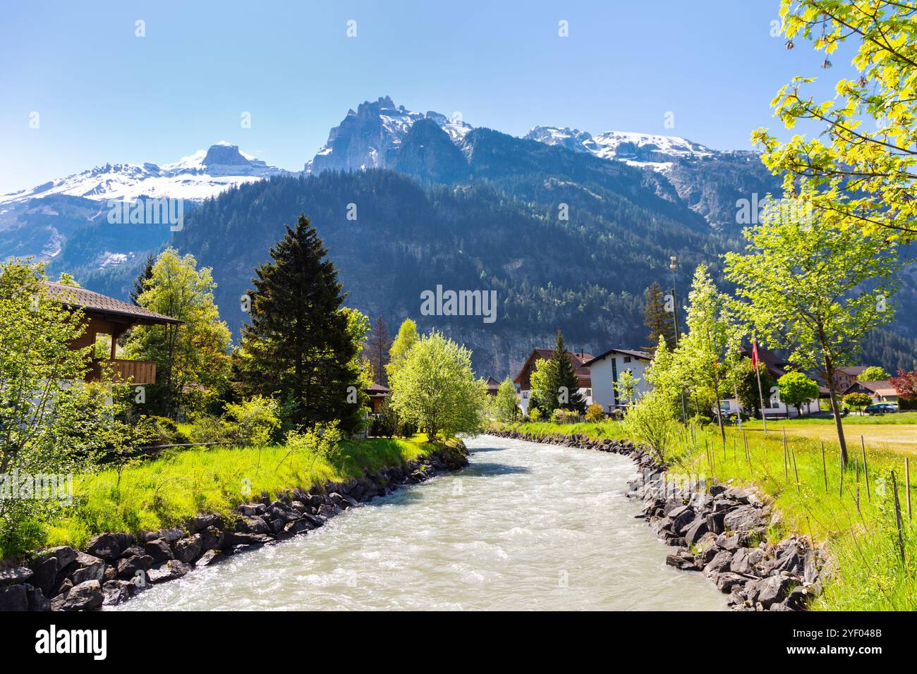 Kander River and traditional wooden Swiss chalet houses, Kandersteg ...