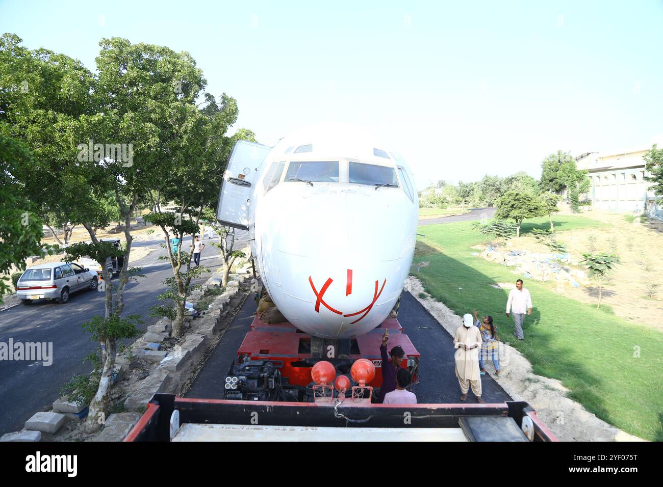 A cargo truck transports an obsolete passenger plane through motorway ...
