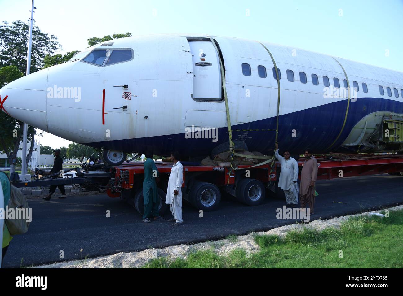 A cargo truck transports an obsolete passenger plane through motorway ...