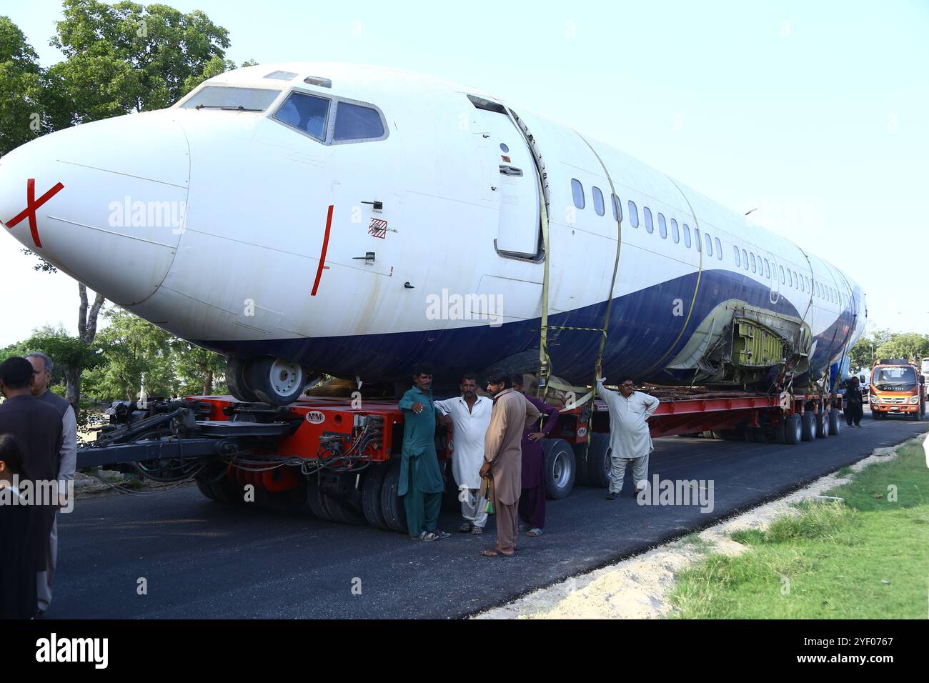 A cargo truck transports an obsolete passenger plane through motorway ...