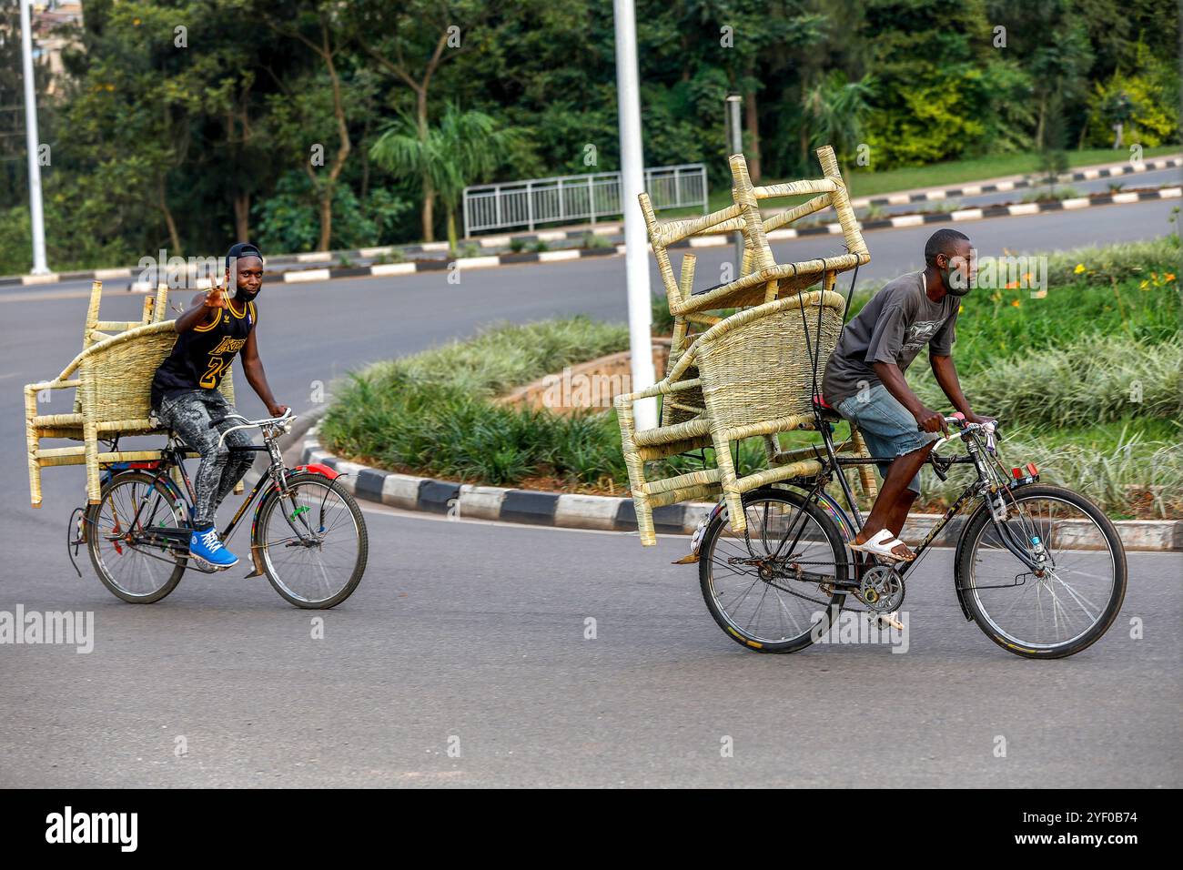 Men riding bikes loaded with furniture in Kigali, Rwanda Stock Photo ...