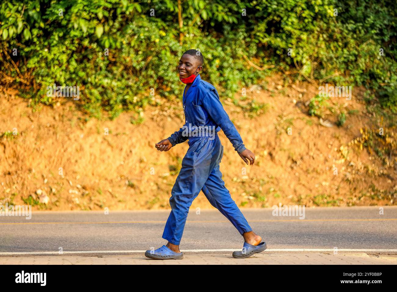 Boy in overalls walking in Kigali, Rwanda Stock Photo - Alamy