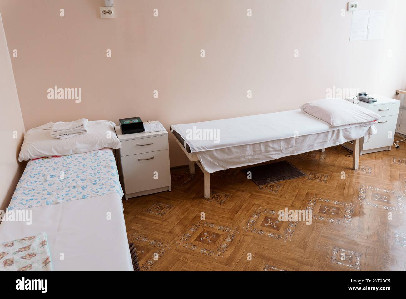 Minimalist Treatment Room with Two Beds and Basic Amenities Stock Photo ...
