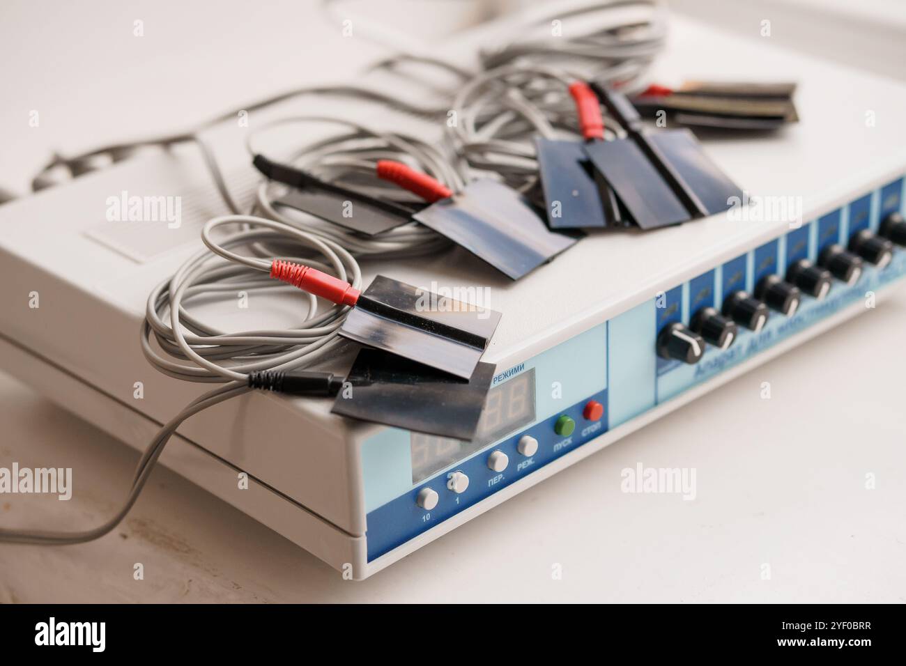 Medical Electrotherapy Device with Electrodes and Wires Stock Photo - Alamy