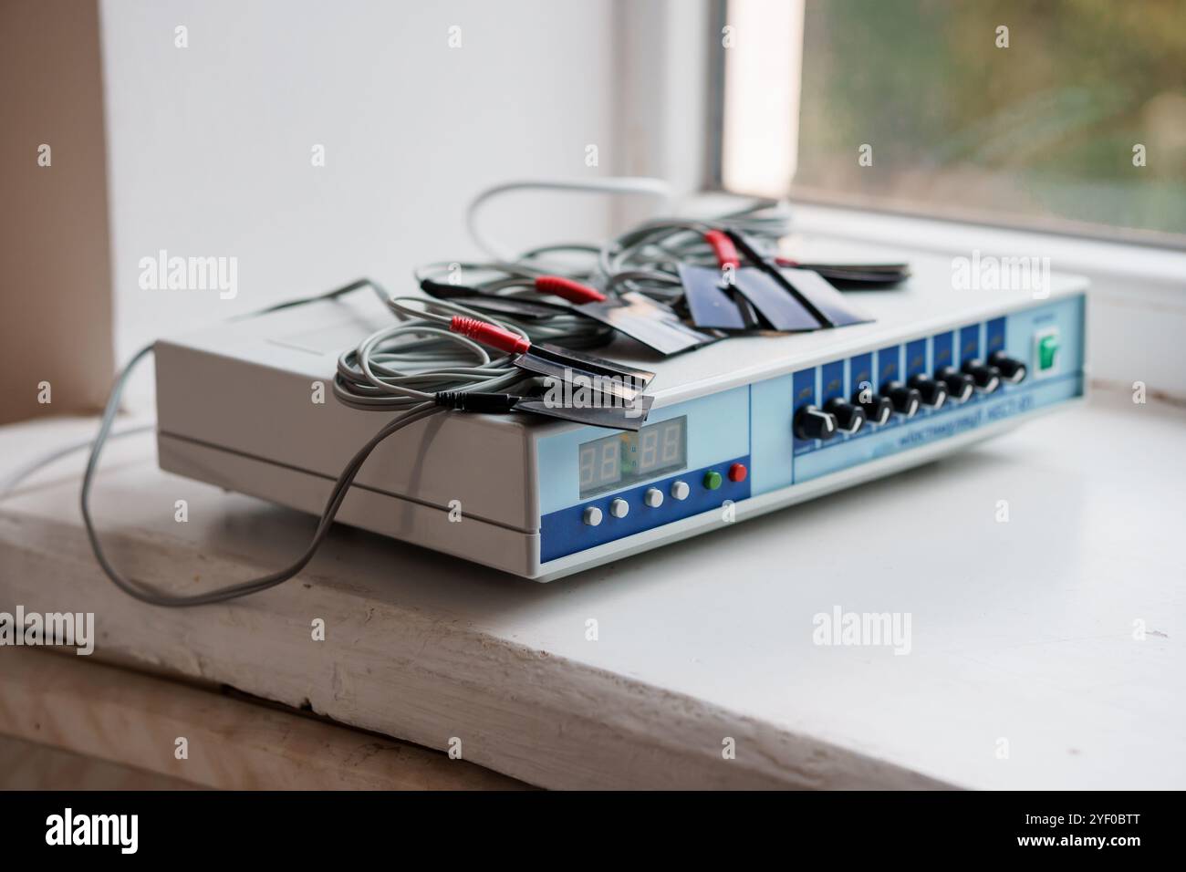 Medical Electrotherapy Device on a Windowsill with Connecting Wires ...