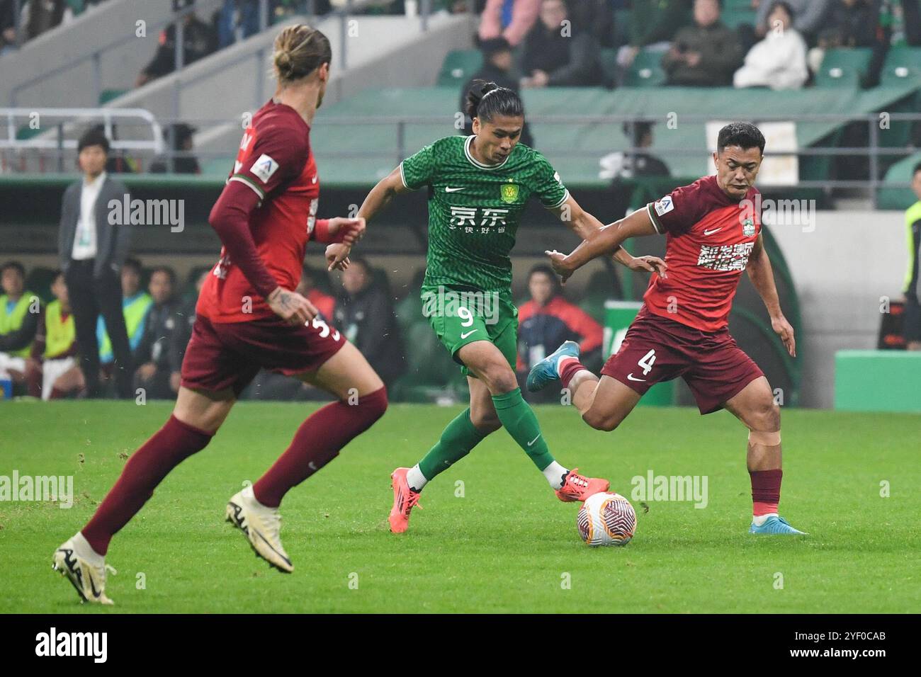 Beijing, China. 2nd Nov, 2024. Zhang Yuning (C) of Beijing Guoan breaks ...