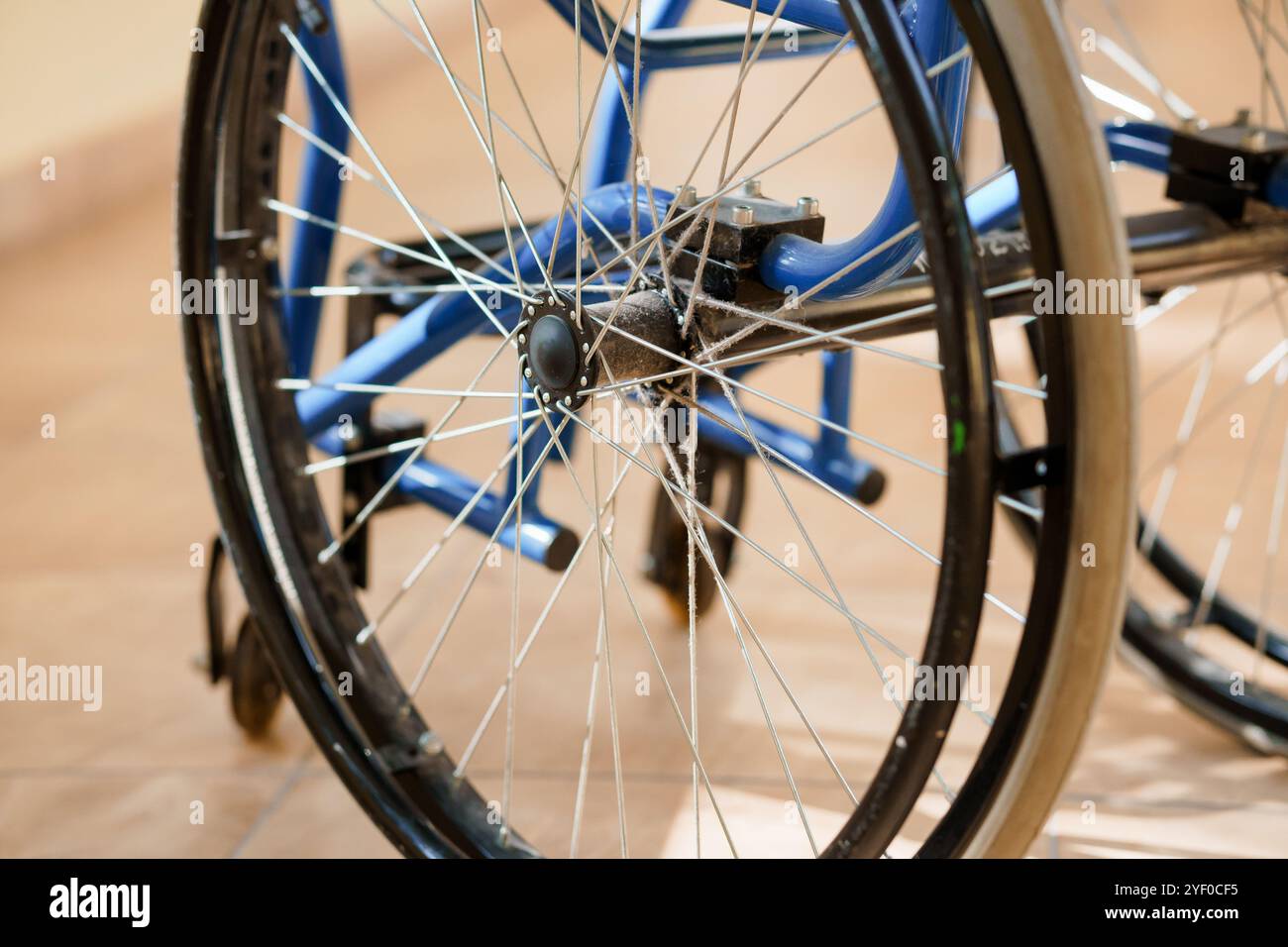 Close-Up View of a Blue Wheelchair Wheel Highlighting Its Spokes and ...