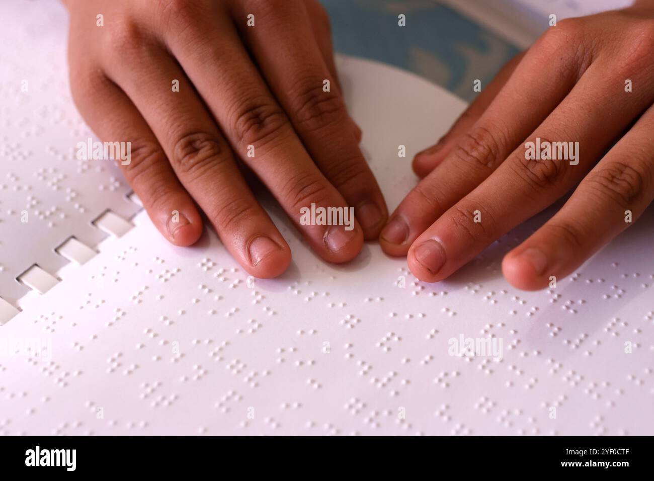 Center for blind children. Blind girl reading braille book Close up on ...