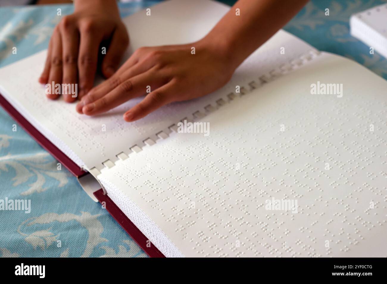 Center for blind children. Blind girl reading braille book Close up on ...