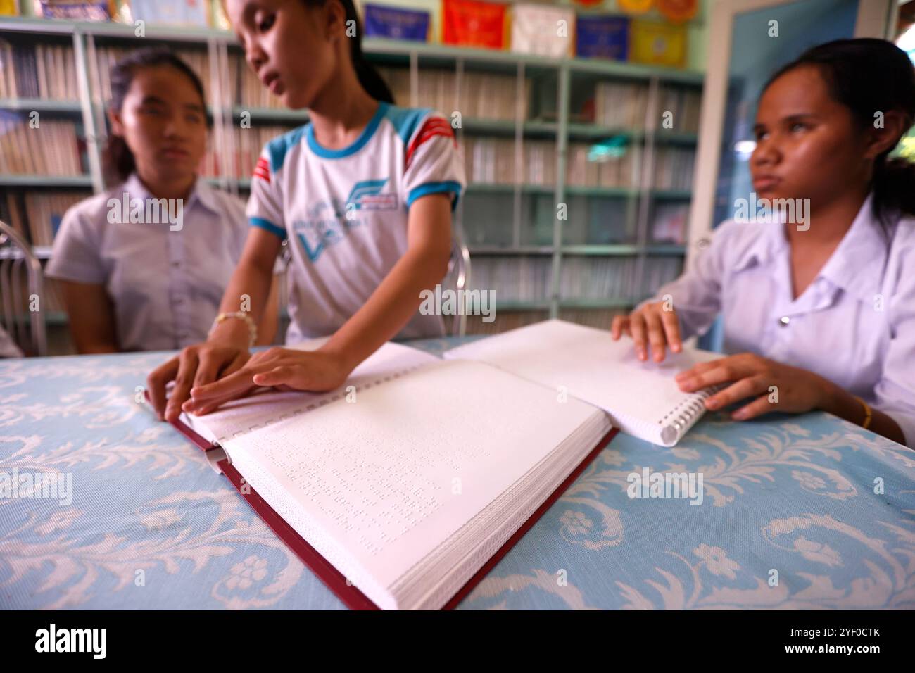 Center for blind children. Blind girls reading braille book Ho Chi Minh ...