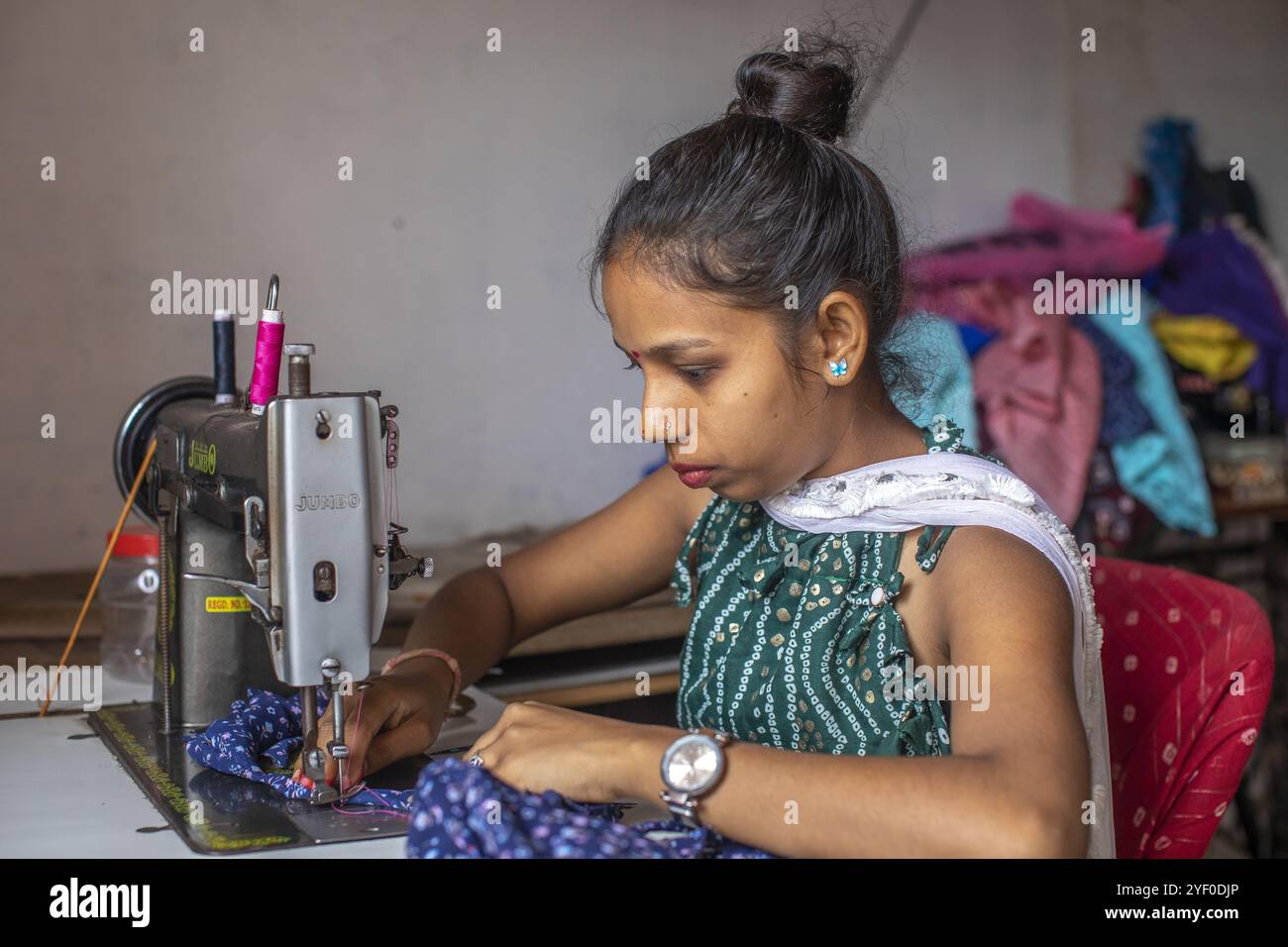 Seamstress at work in a village in Narmada district, Gujarat, India ...