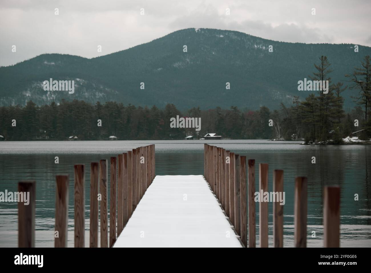 Snow covered dock frozen icy Lake George New York's Adirondack Mountain ...